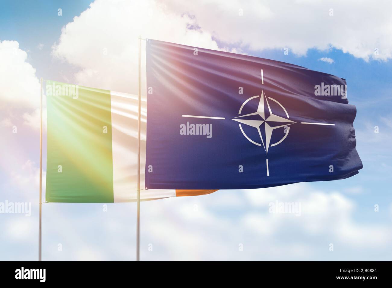 Sunny blue sky and flags of nato and ireland Stock Photo - Alamy
