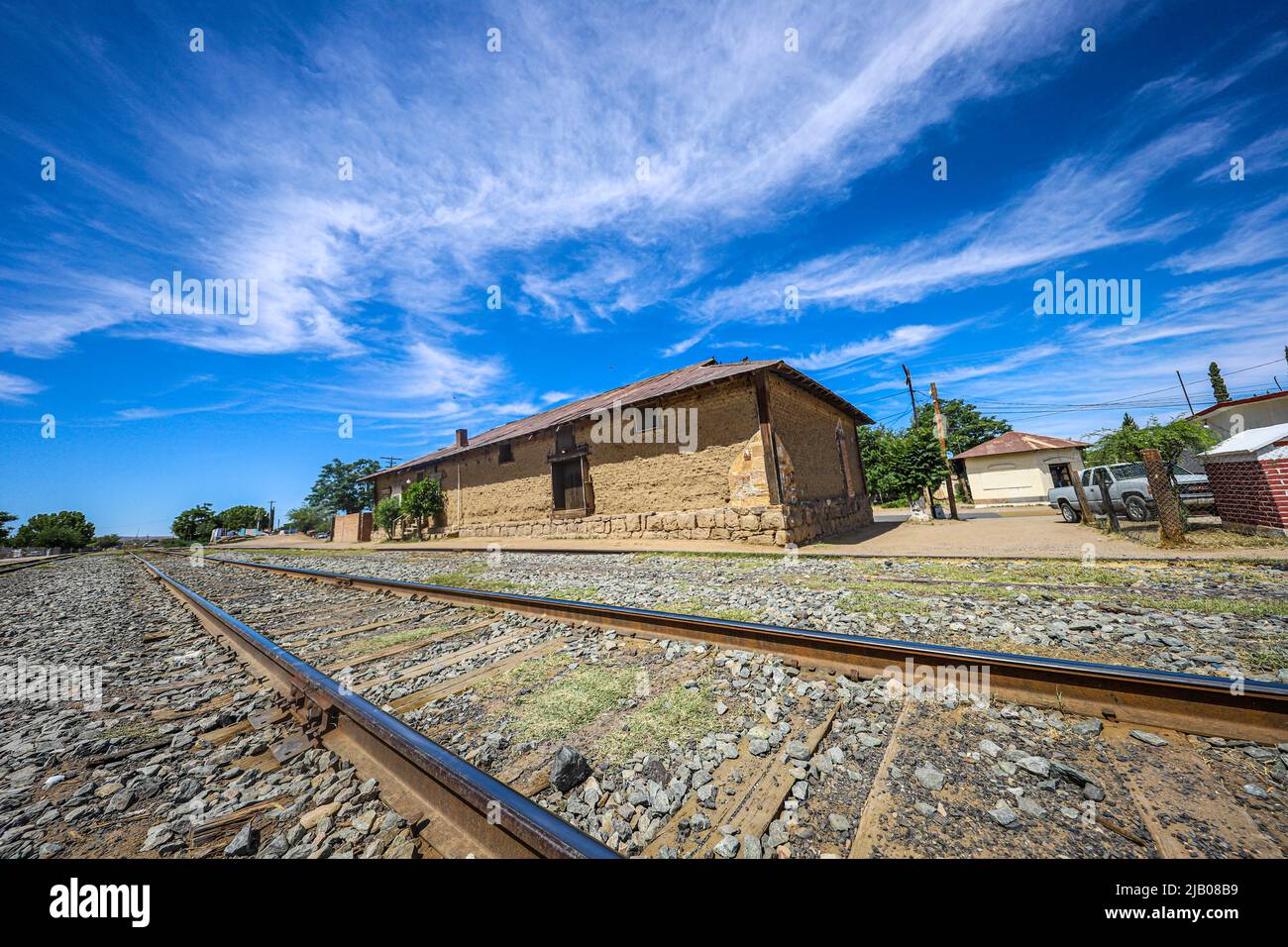 Train tracks, railway and old adobe train station in Esqueda, Mexico ...