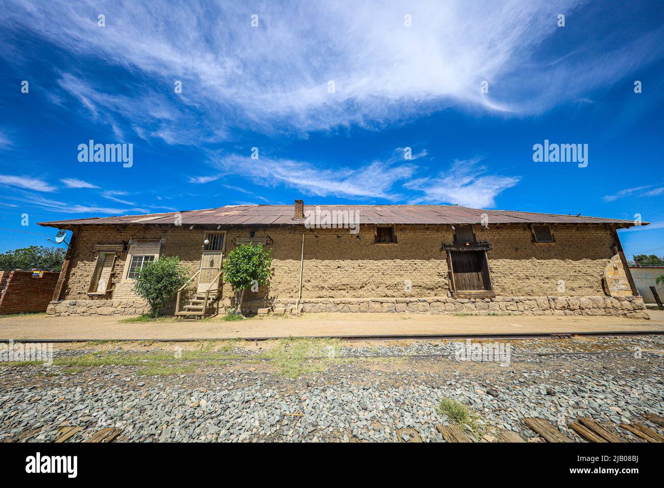 Train tracks, railway and old adobe train station in Esqueda, Mexico ...