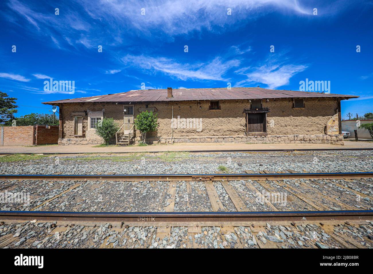 Train tracks, railway and old adobe train station in Esqueda, Mexico ...
