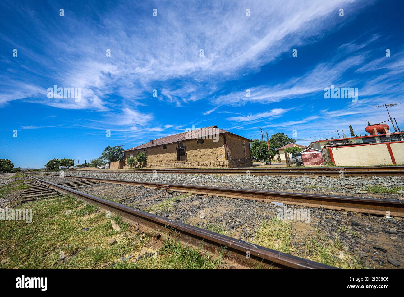 Train tracks, railway and old adobe train station in Esqueda, Mexico ...