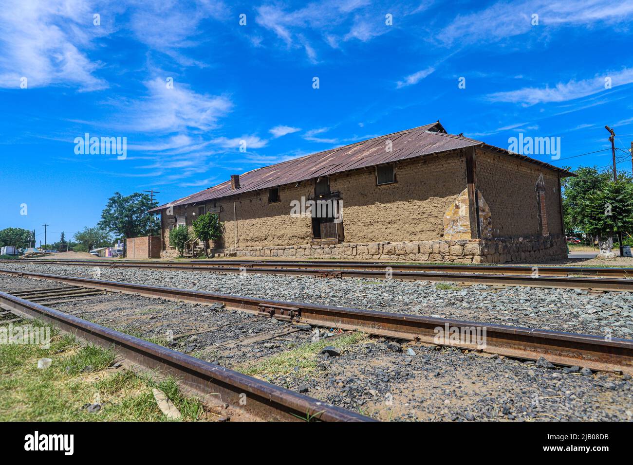 Train tracks, railway and old adobe train station in Esqueda, Mexico ...