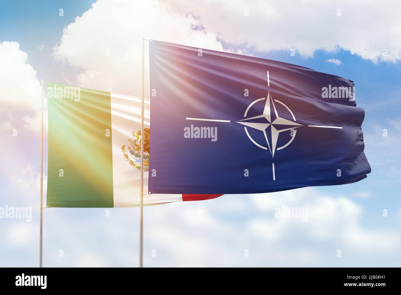 Sunny blue sky and flags of nato and mexico Stock Photo - Alamy