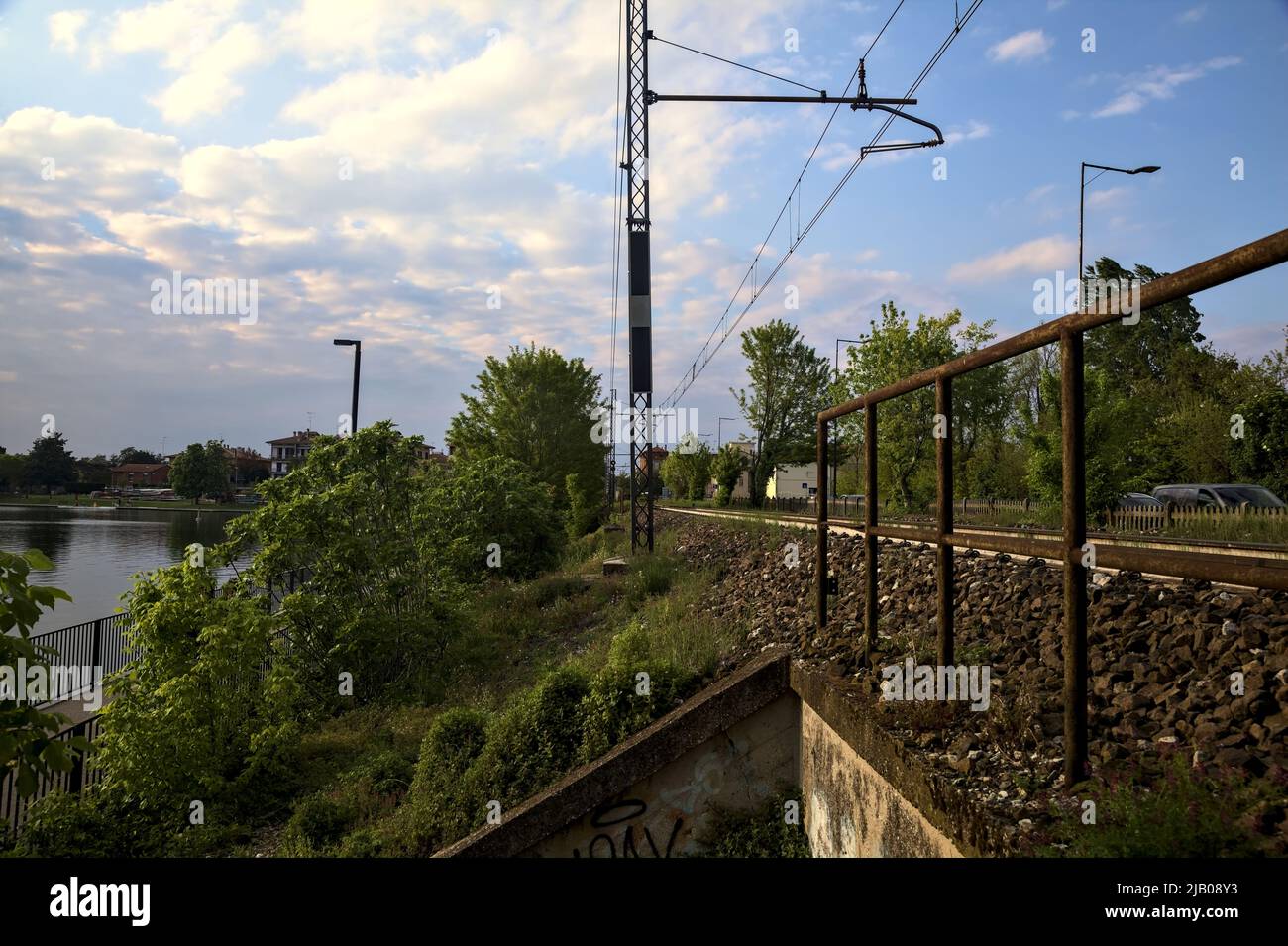 Railroad track on an embankment in a park at sunset Stock Photo - Alamy