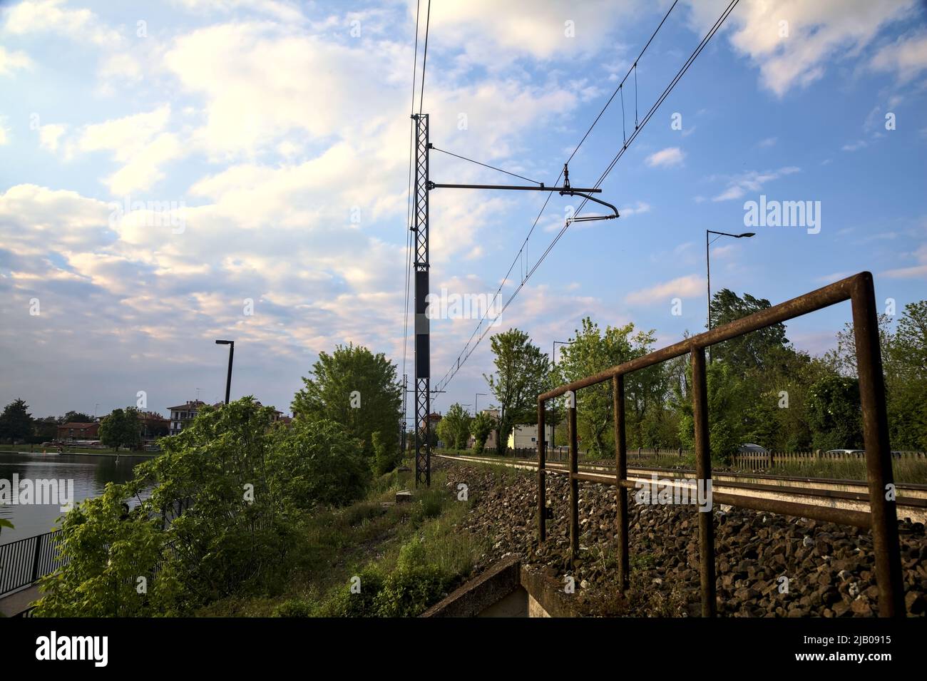 Railroad track on an embankment in a park at sunset Stock Photo - Alamy