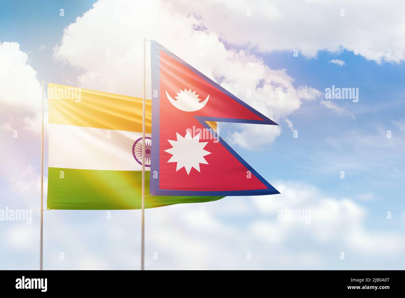 Sunny blue sky and flags of nepal and india Stock Photo - Alamy