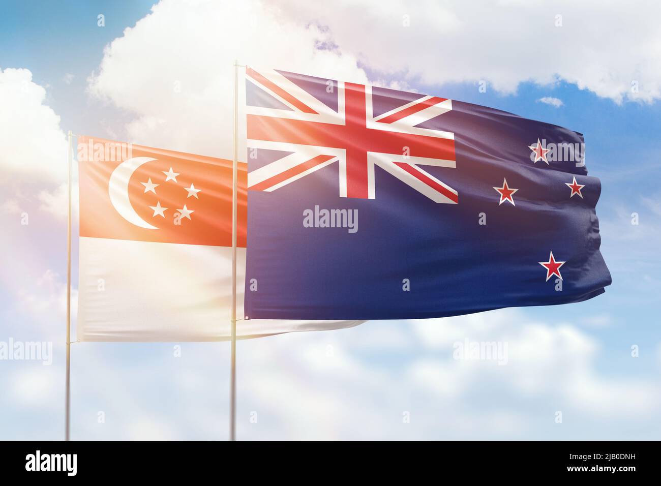 Sunny blue sky and flags of new zealand and singapore Stock Photo - Alamy