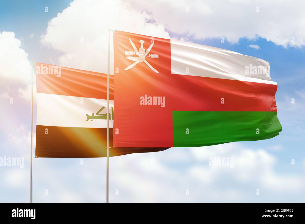 Sunny blue sky and flags of oman and iraq Stock Photo - Alamy