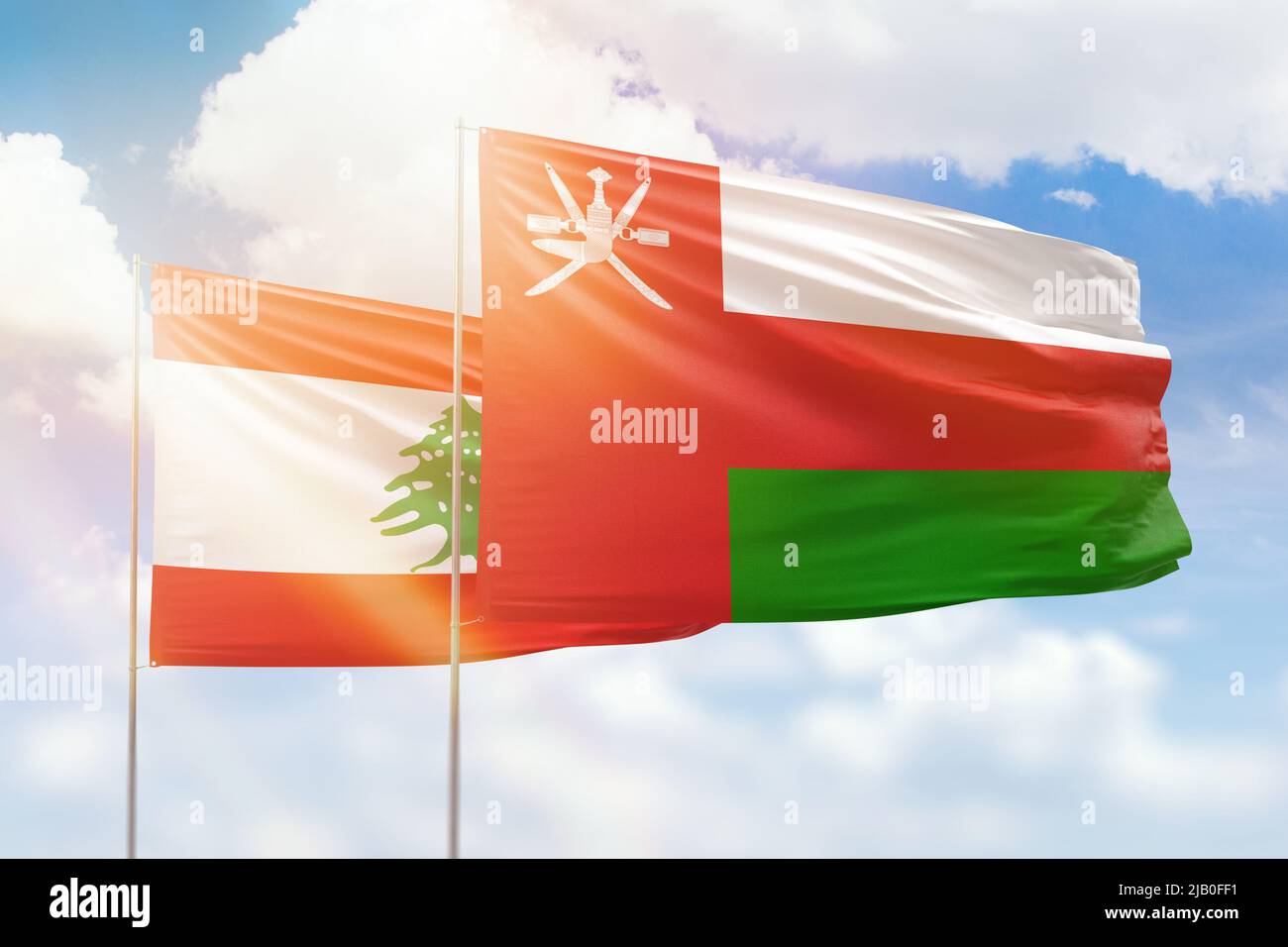 Sunny blue sky and flags of oman and lebanon Stock Photo - Alamy