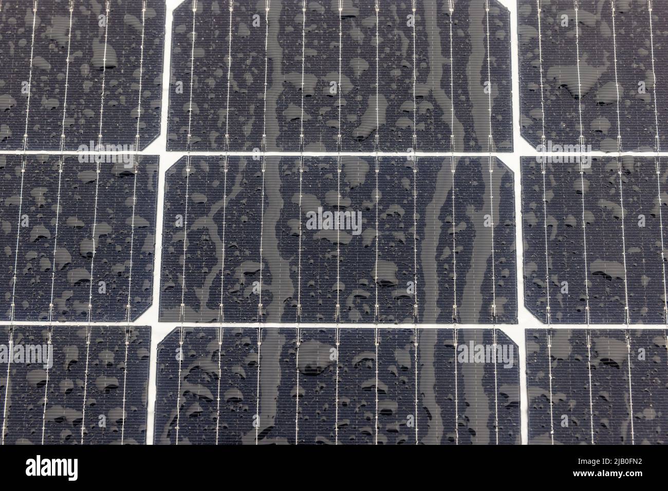 Photovoltaic solar energy panels in rainy seasons. Water raindrops on ...