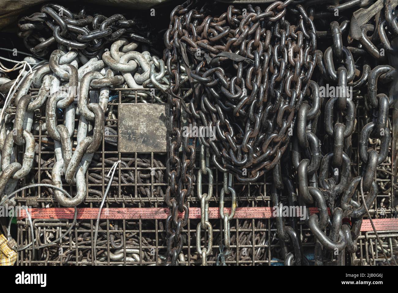 Old metal chain links stocked in store. Chains for heavy industrial use ...
