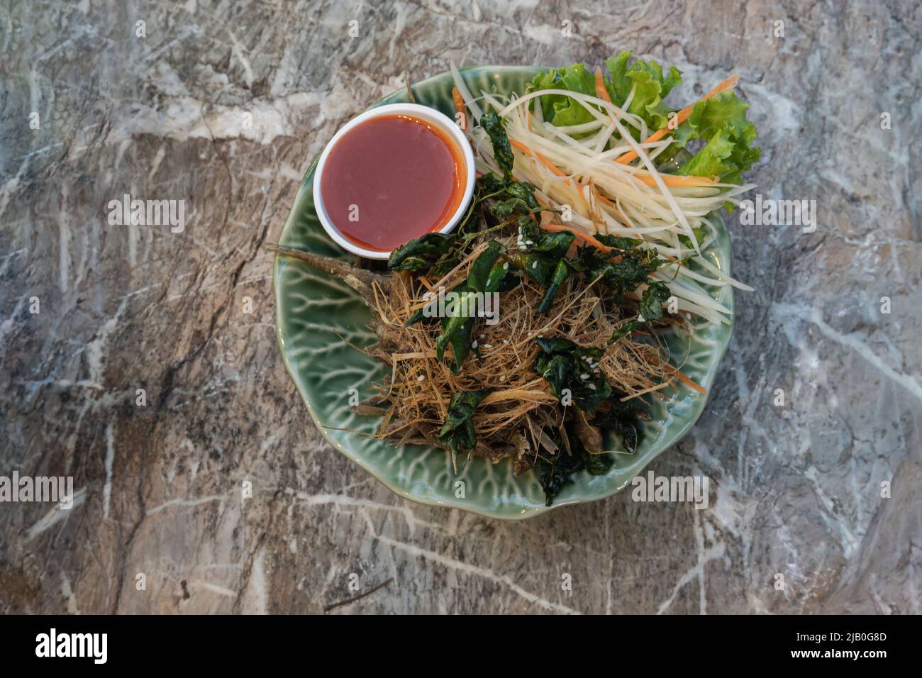 Deep fried horseface loach fish fried or Crispy fried Banana-root ...