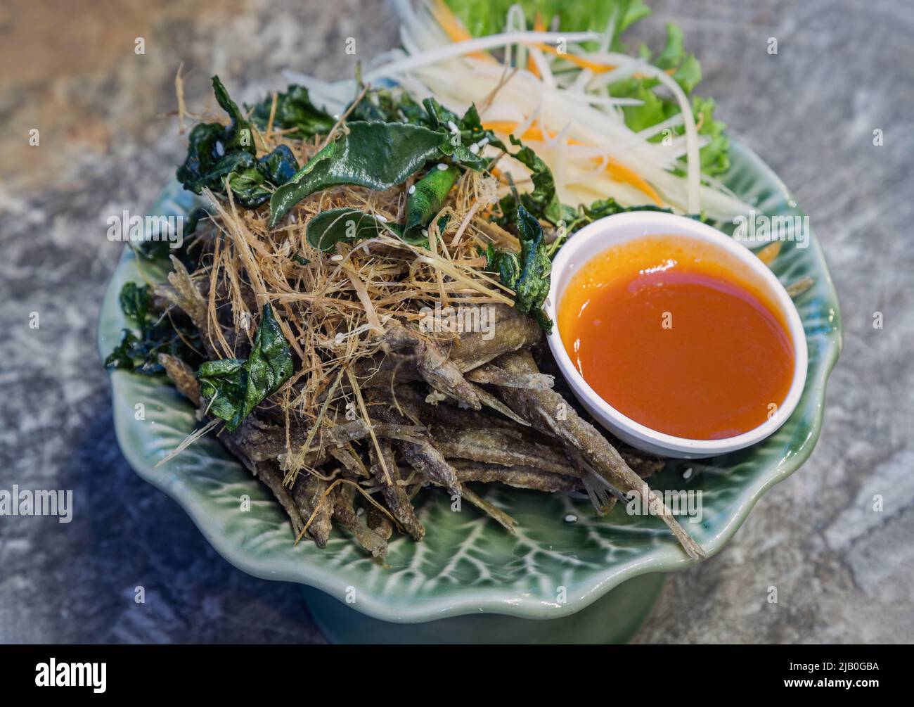 Deep fried horseface loach fish fried or Crispy fried Banana-root ...