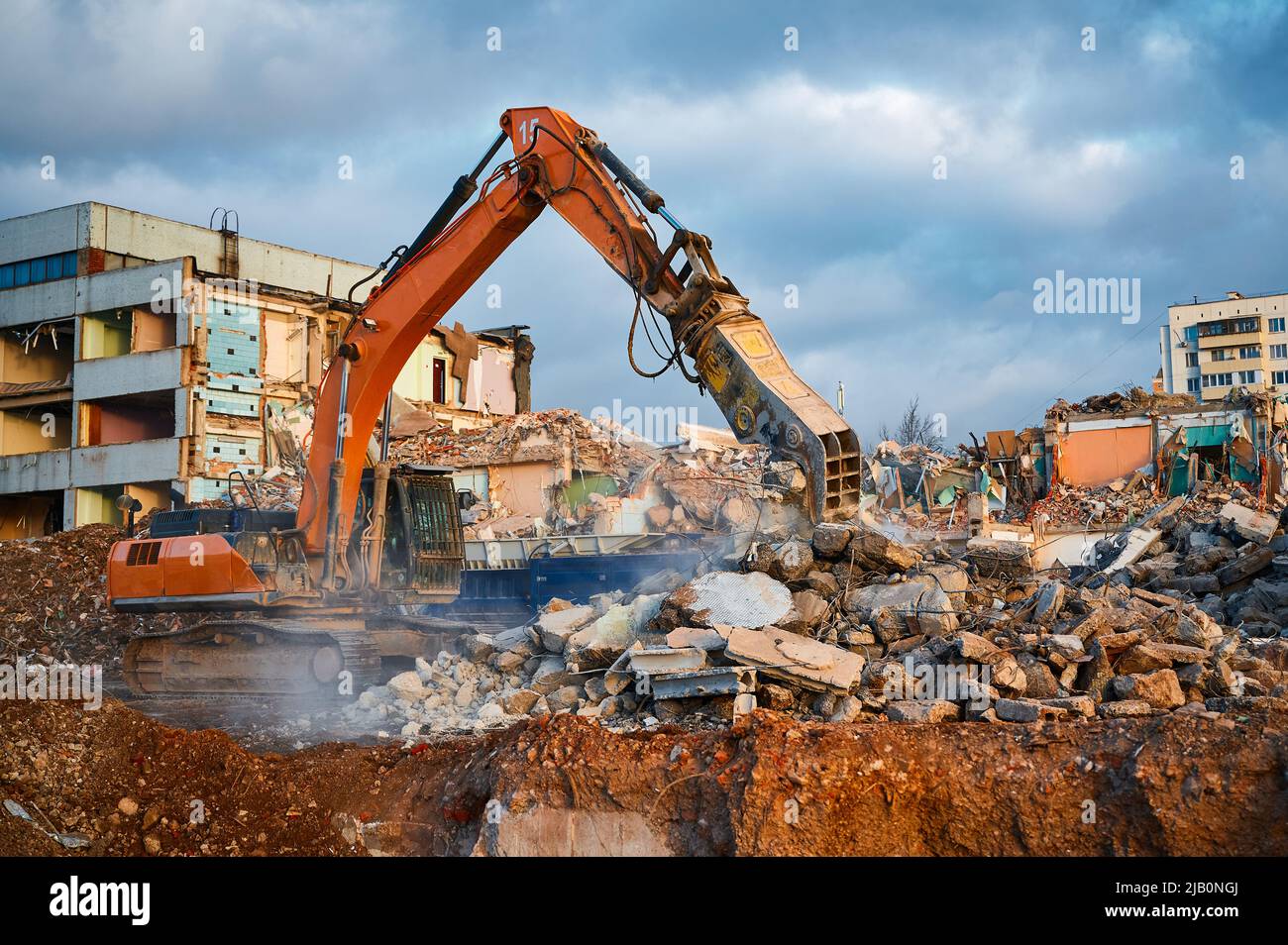 Excavator destroyer with hydraulic scissors cuts concrete Stock Photo ...