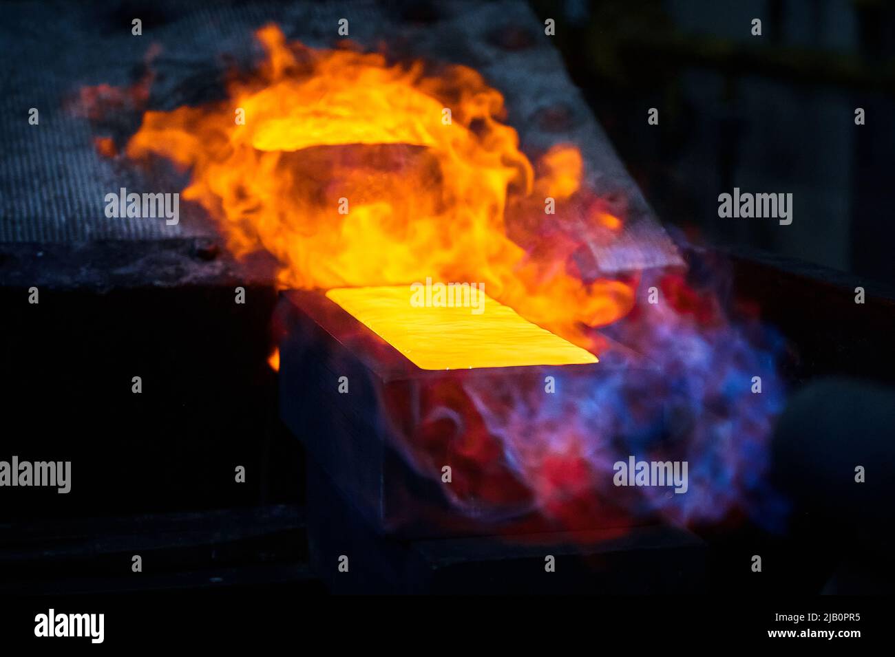 Hot gold ingot chills in casting form in shielding gases Stock Photo ...