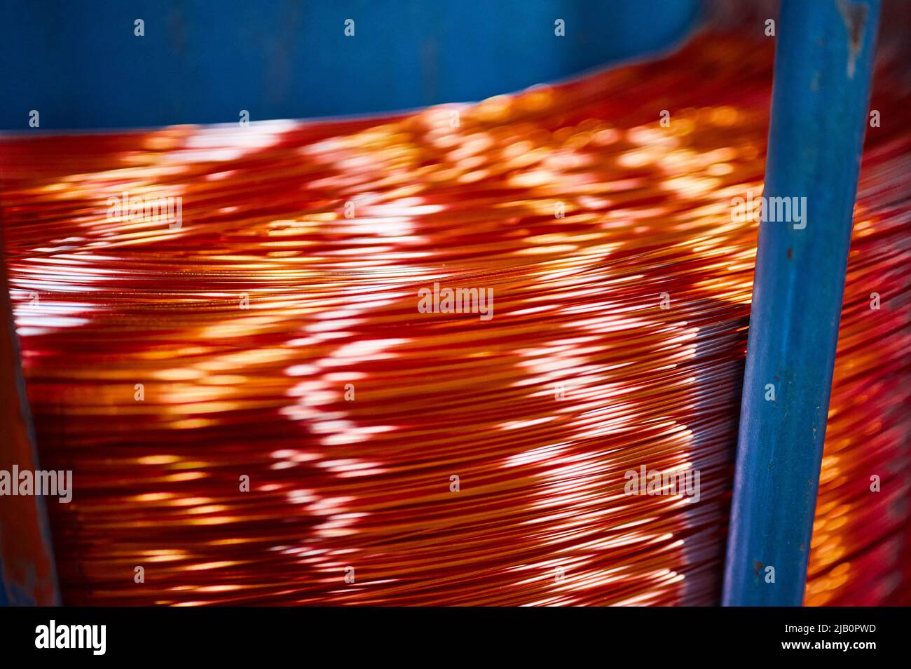 Large bobbin of orange copper wire in light warehouse Stock Photo - Alamy