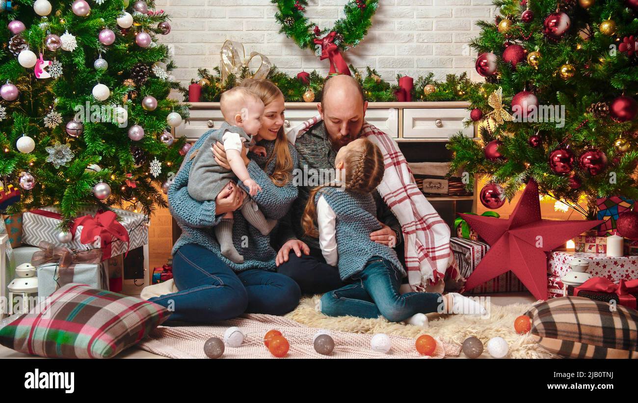 Happy successful family sits in the Christmas setting in the living ...