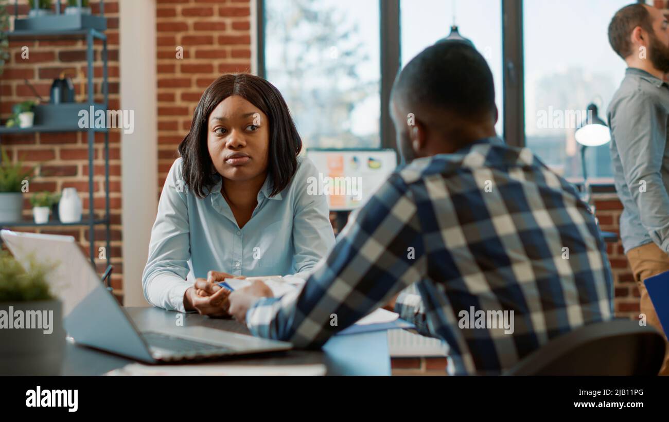 African american man and woman attendng job interview, having ...