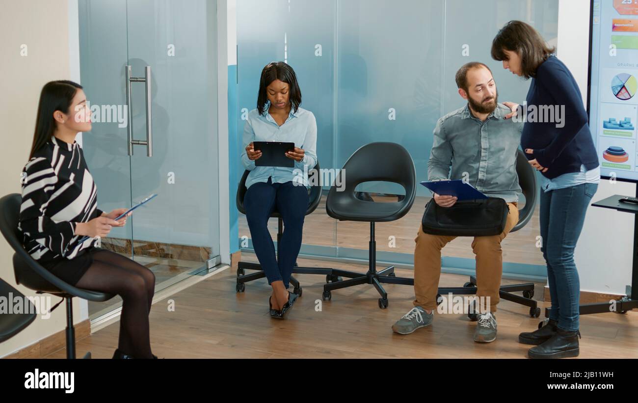 Man attending job interview appointment with pregnant HR recruiter ...