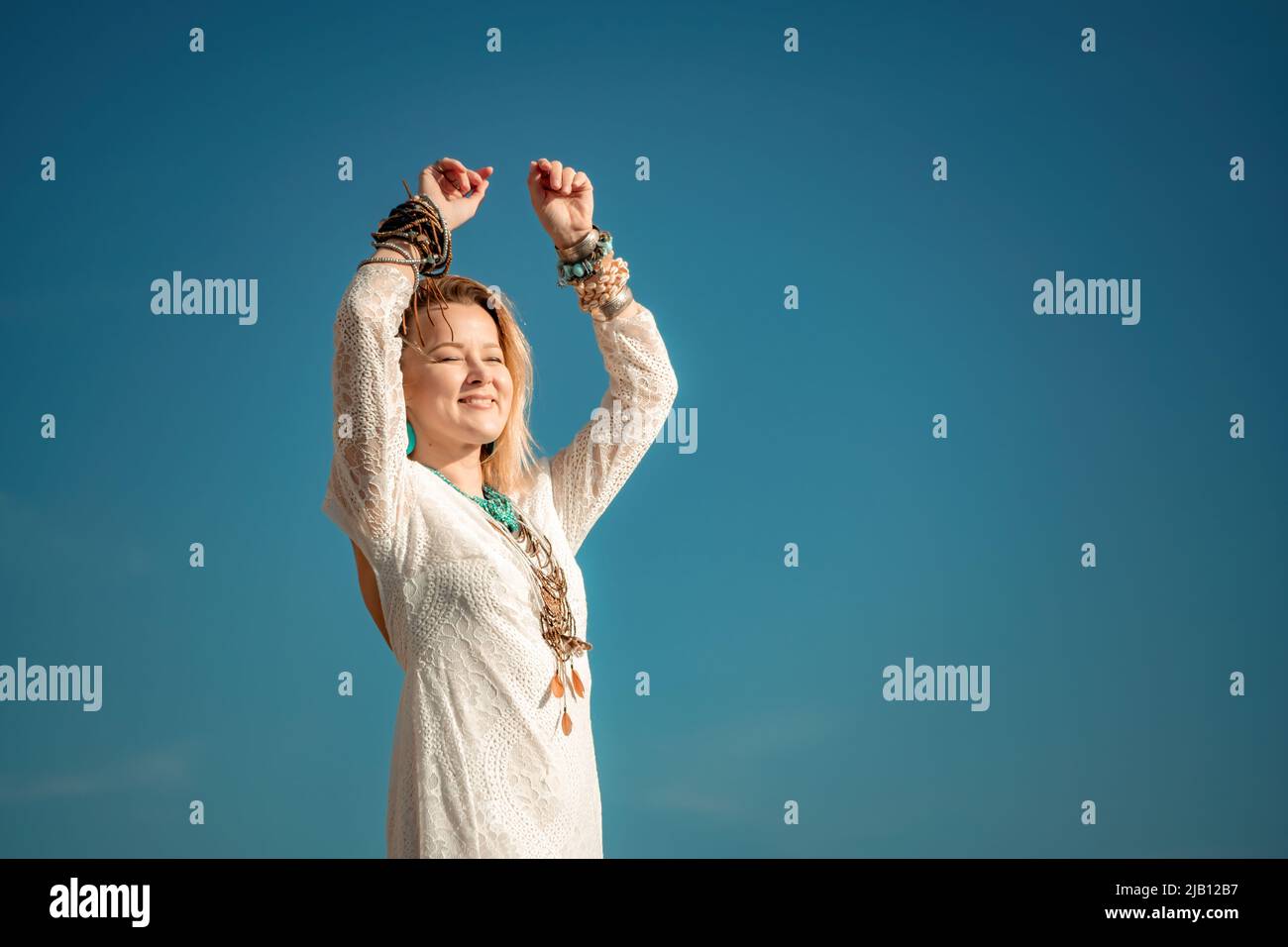 Woman in bohemian clothing on beach at sunset. Boho style for ...