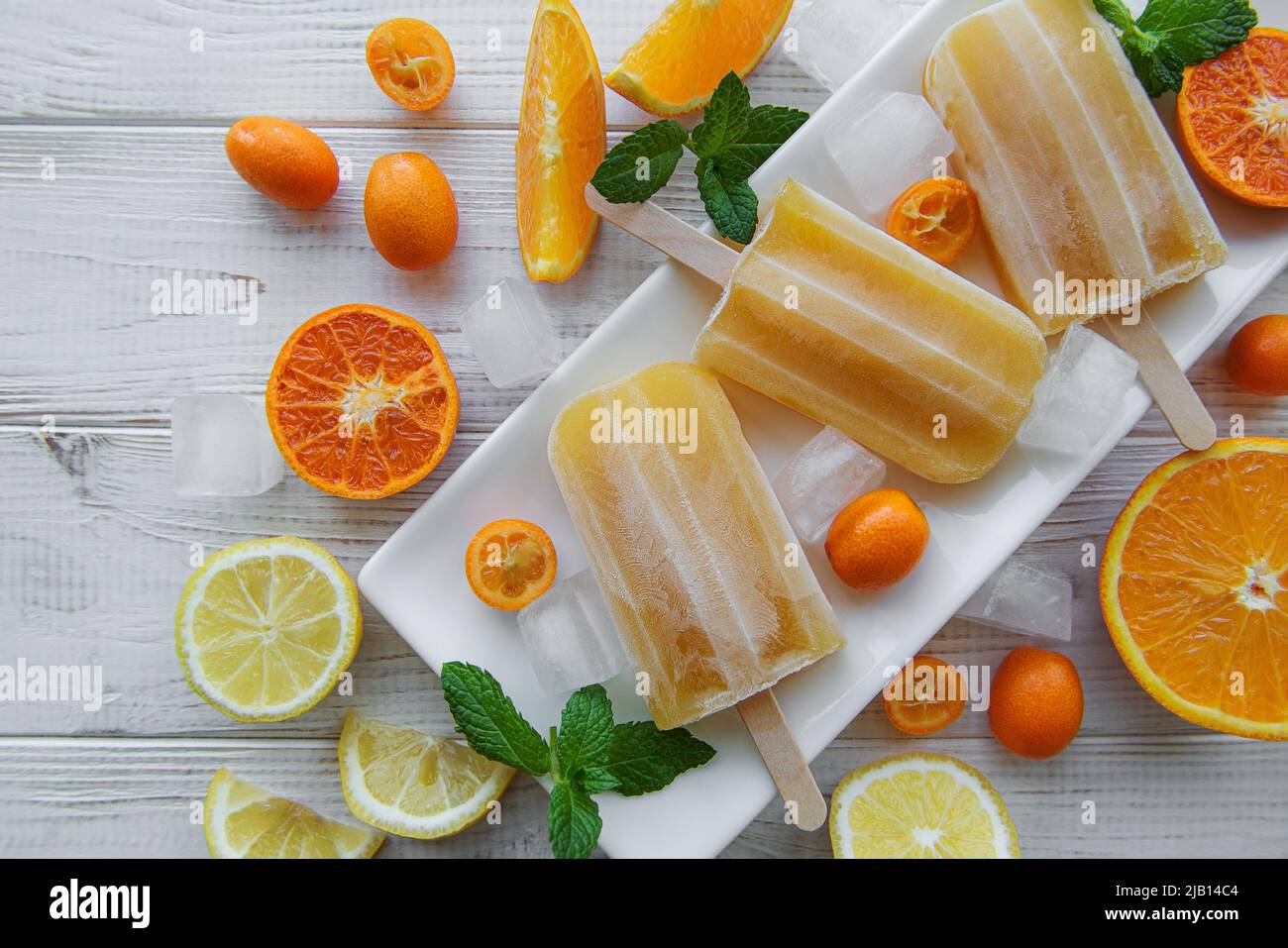 Fruit orange ice popsicle, ice cubes and slices of citrus fruits Stock ...