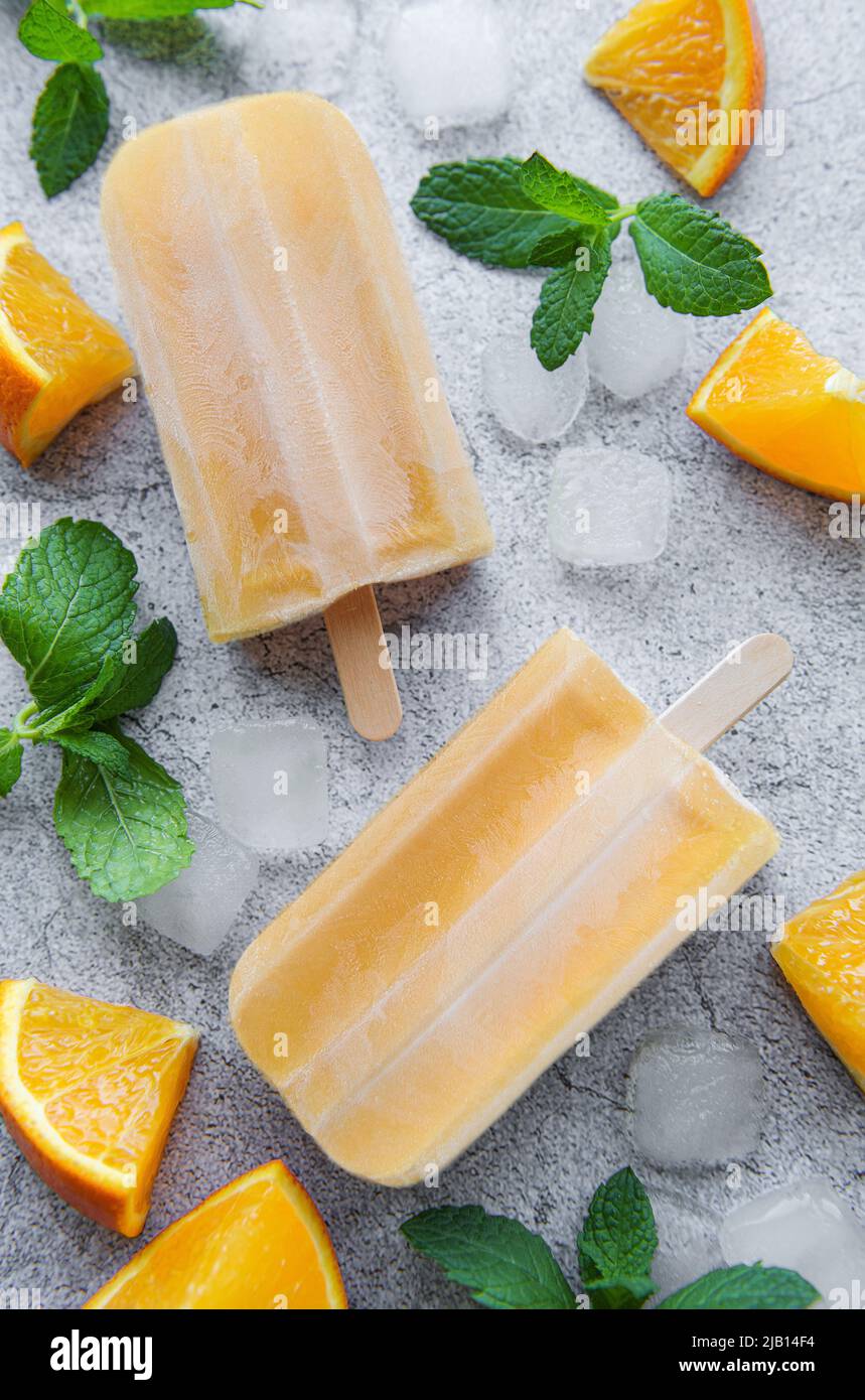 Fruit orange ice popsicle, ice cubes and slices of citrus fruits Stock ...
