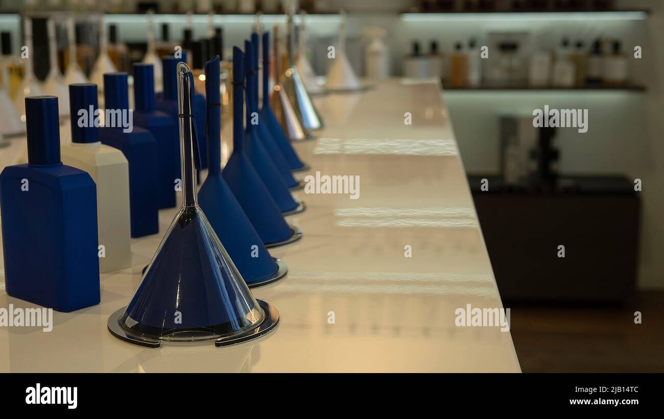 Perfume bottles and funnels with fragrance on the counter in a luxury ...