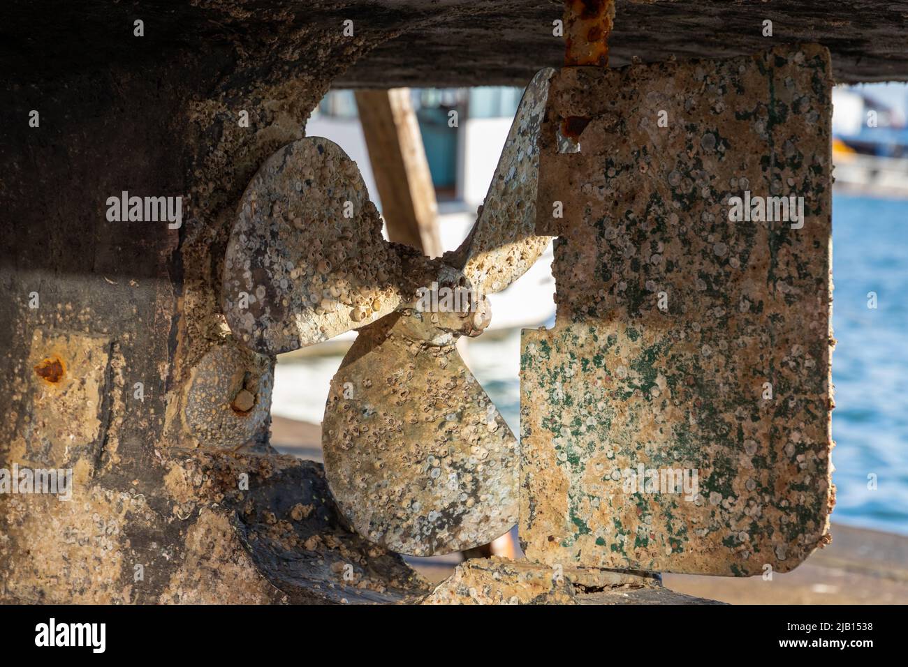 Rusty old boat propeller and rudder, close up photo with selective ...
