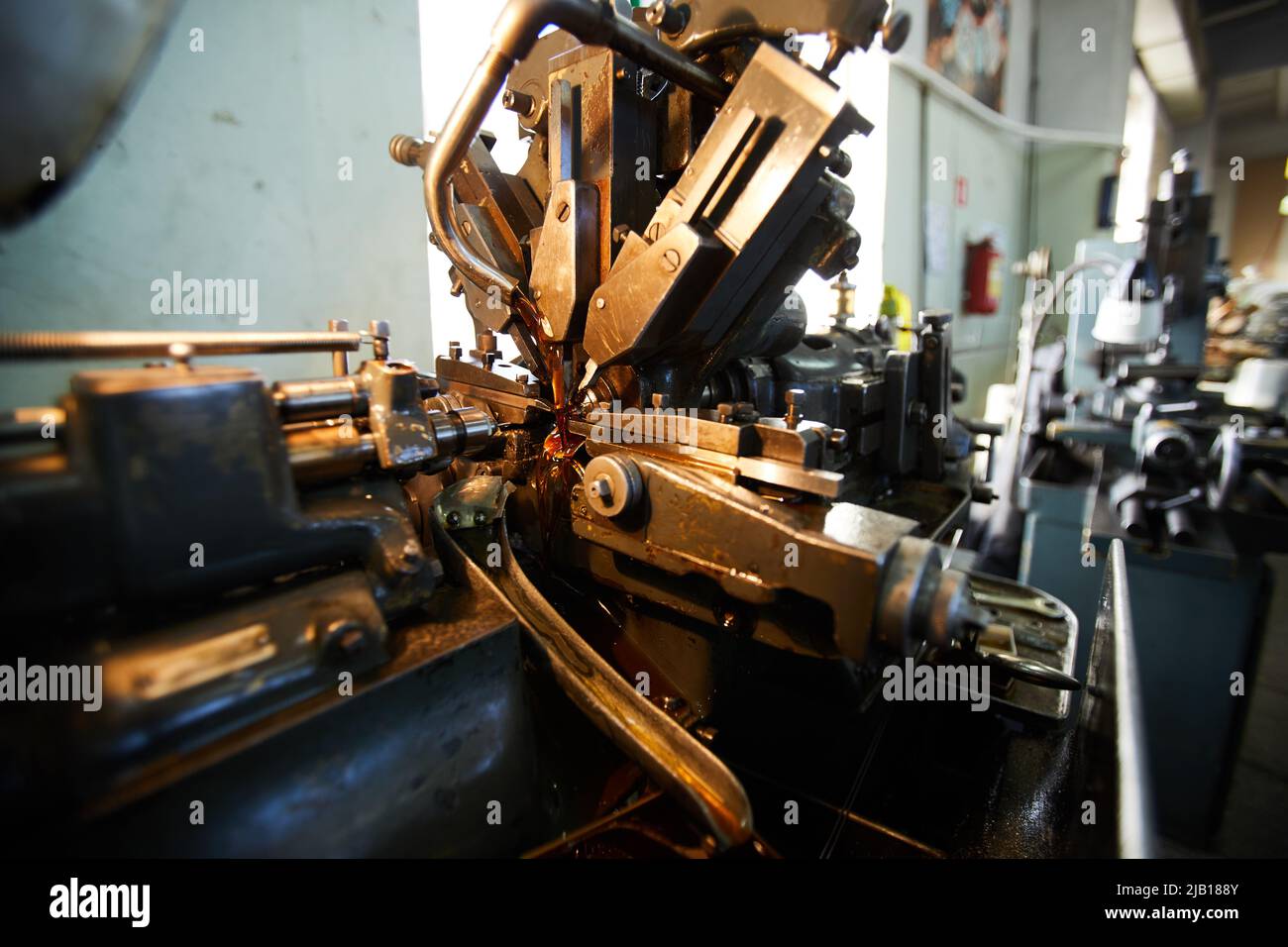 Close-up of lathe milling machine with copper parts joining together ...