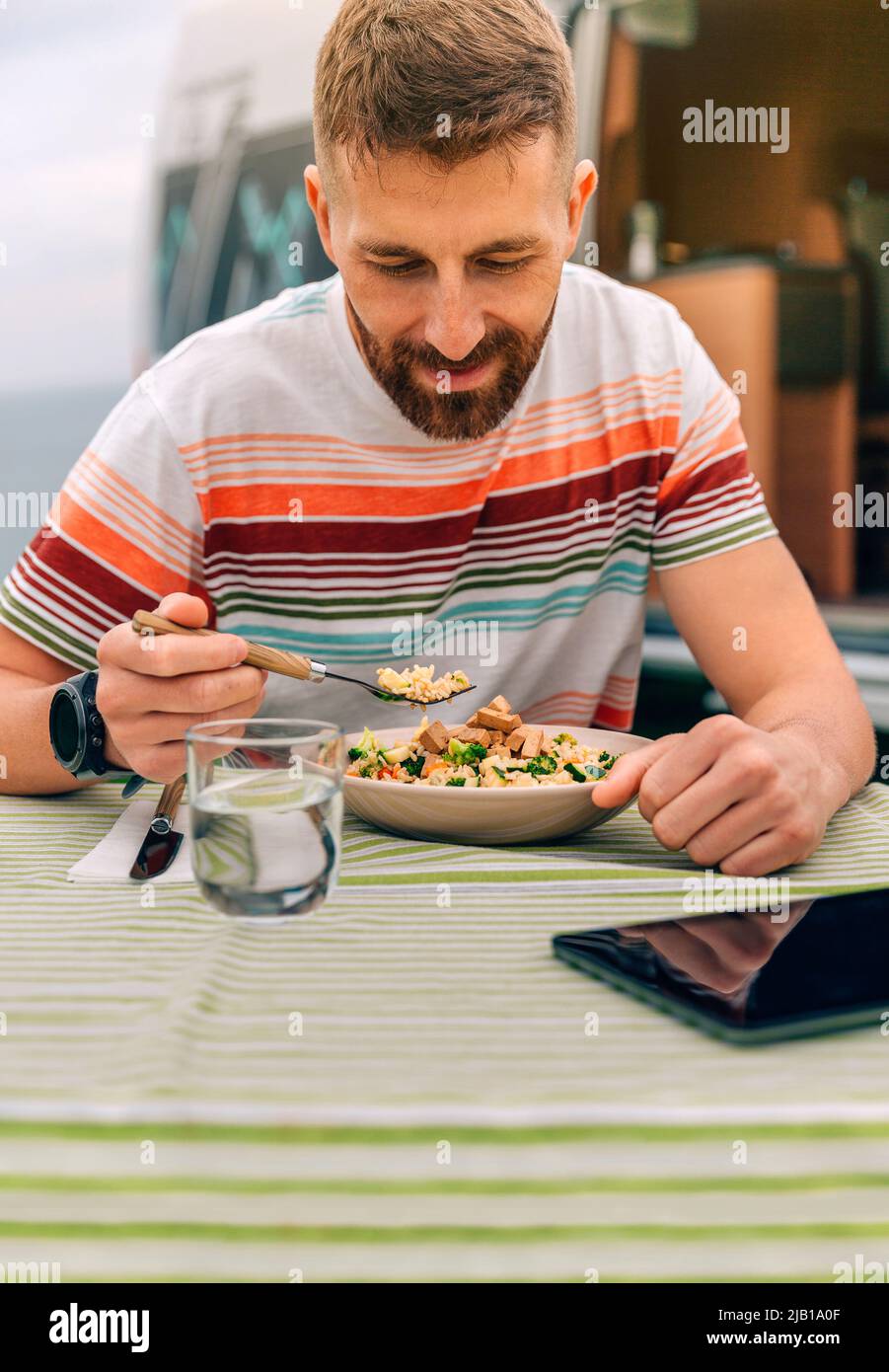 Man eating vegan food outdoors Stock Photo - Alamy