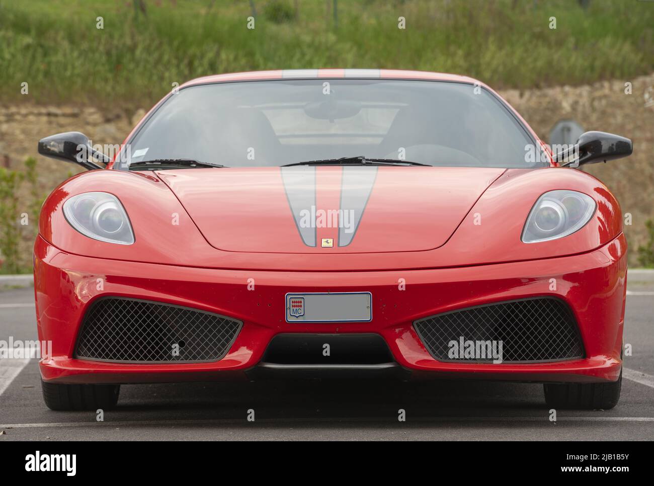 Classic sporty red Ferrari in the parking lot Stock Photo - Alamy
