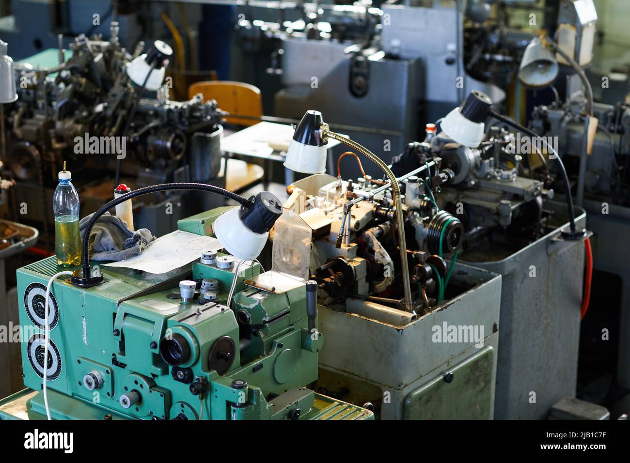 Interior of factory shop with modern equipment and lamps at watch ...