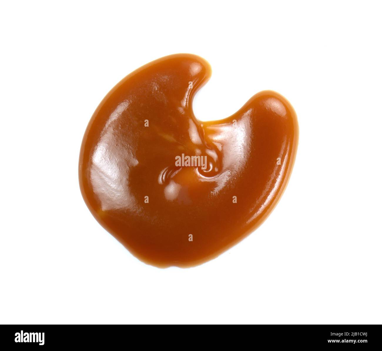 Sweet caramel sauce isolated on white background close up. Golden ...