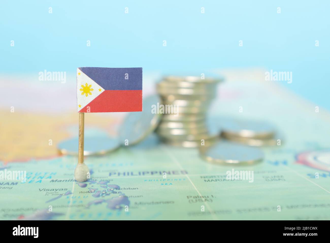 Selective focus of Philippine flag in blurry world map with coins ...