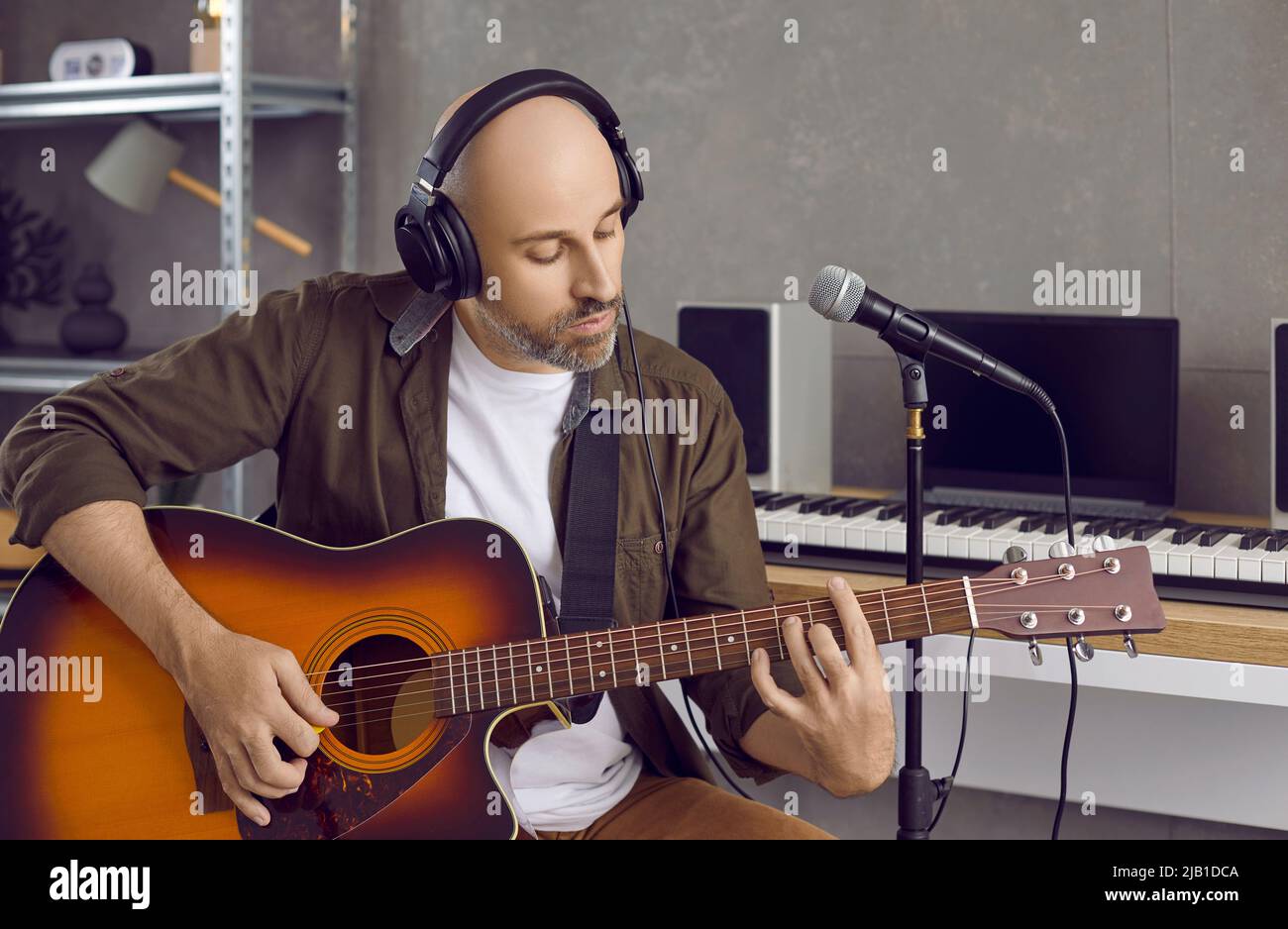 Caucasian man play guitar sing in microphone Stock Photo - Alamy