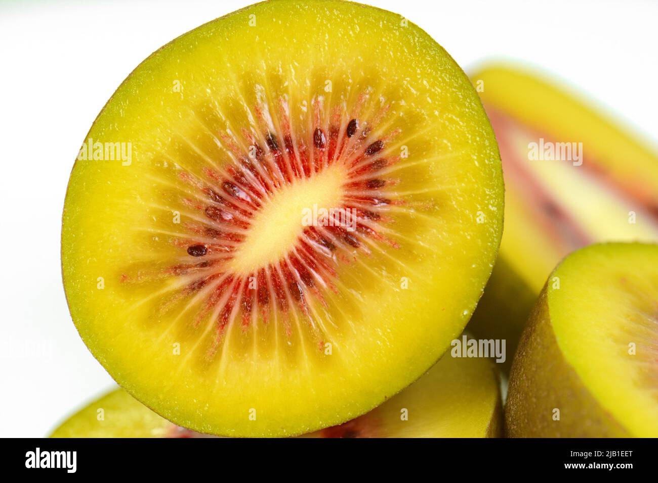 fresh red kiwi fruit and a cut one on a white background Stock Photo ...