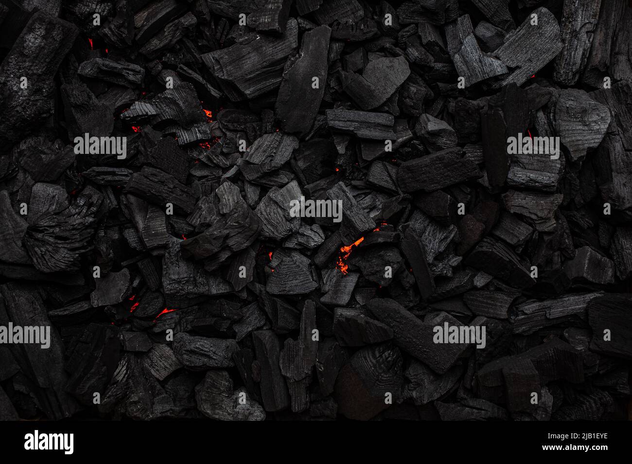 Charcoal with red streaks of heat. Textured dark background Stock Photo ...