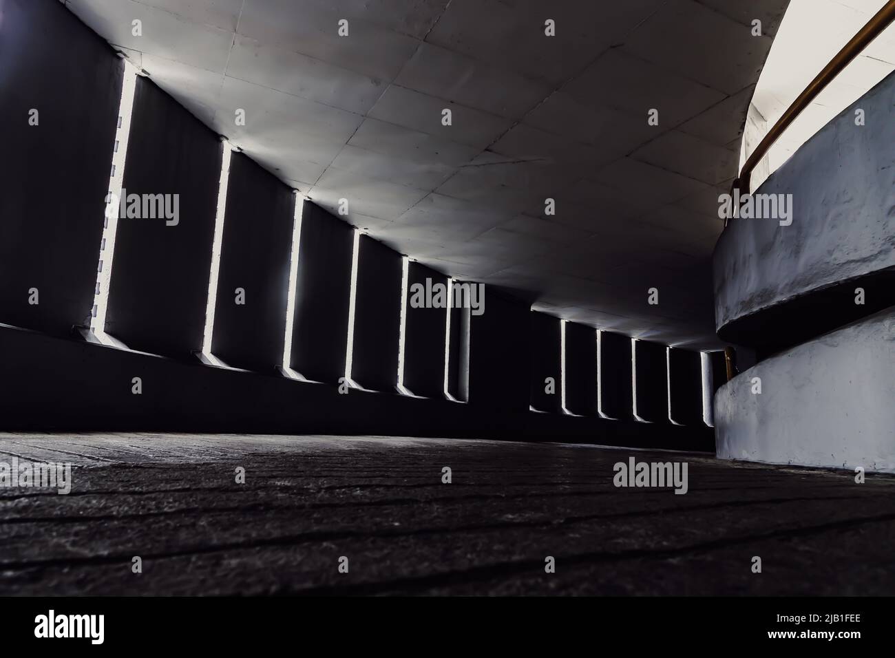 Light channels from cement wall of Curving shaped ramp on high building ...