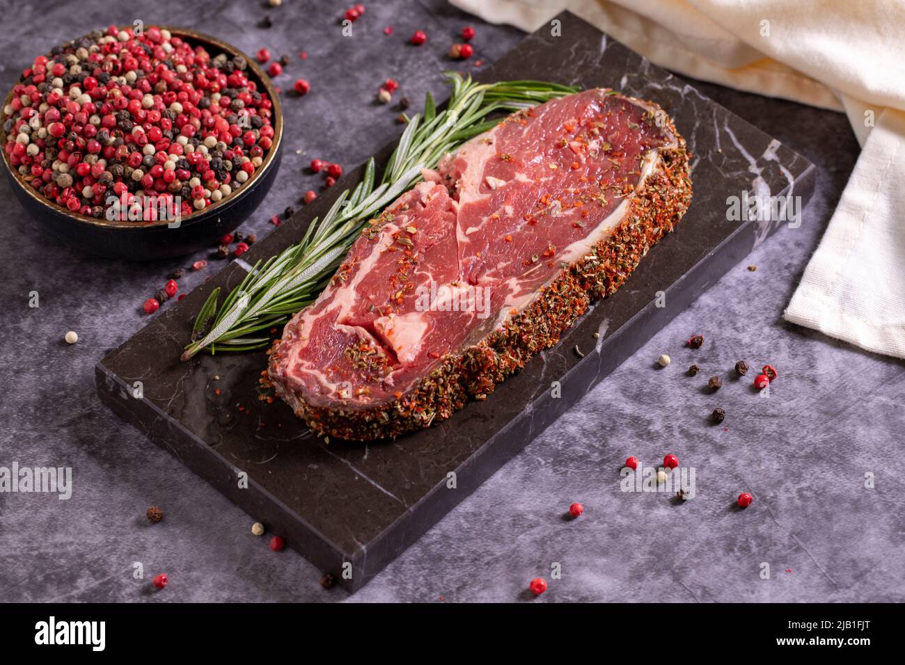 Beef ribeye on a dark background. Fresh raw beef ribeye with spices ...