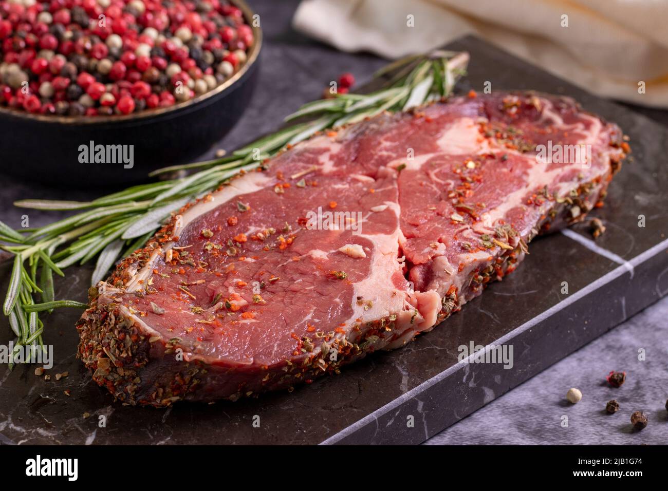 Beef ribeye on a dark background. Fresh raw beef ribeye with spices ...