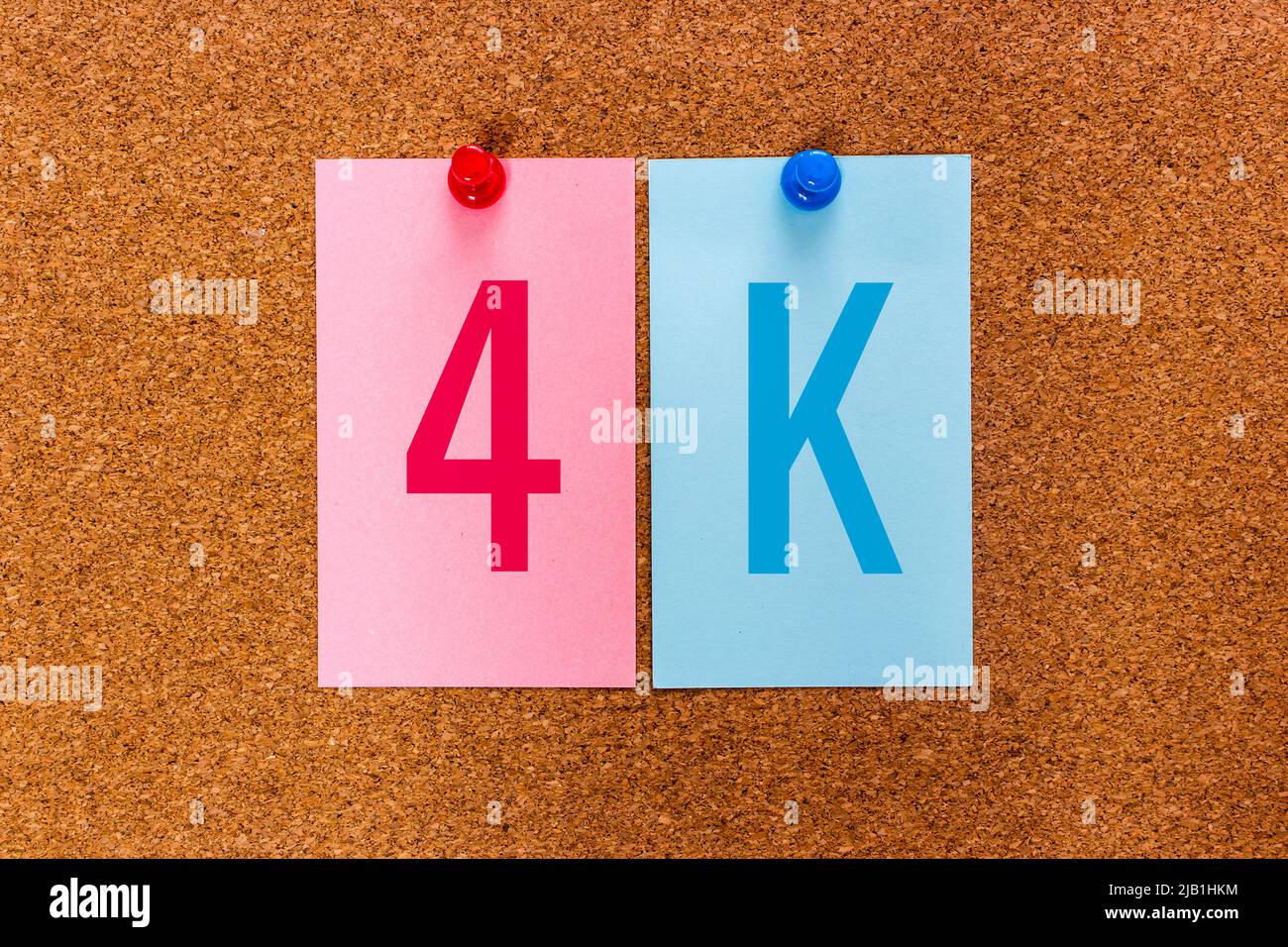 2 letters keyword 4K on multicolored stickers attached to a cork board ...