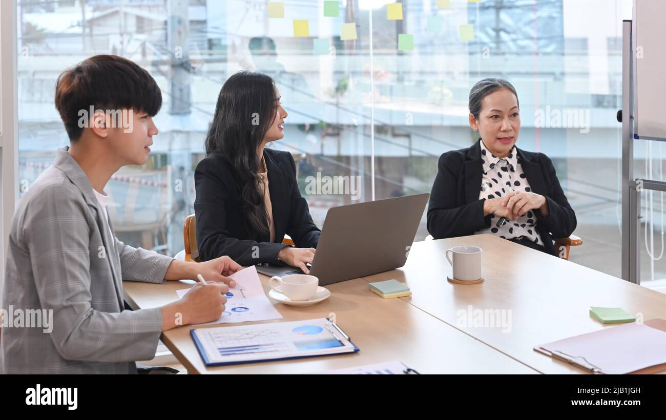 Senior older female executive ceo and young employee discuss corporate ...