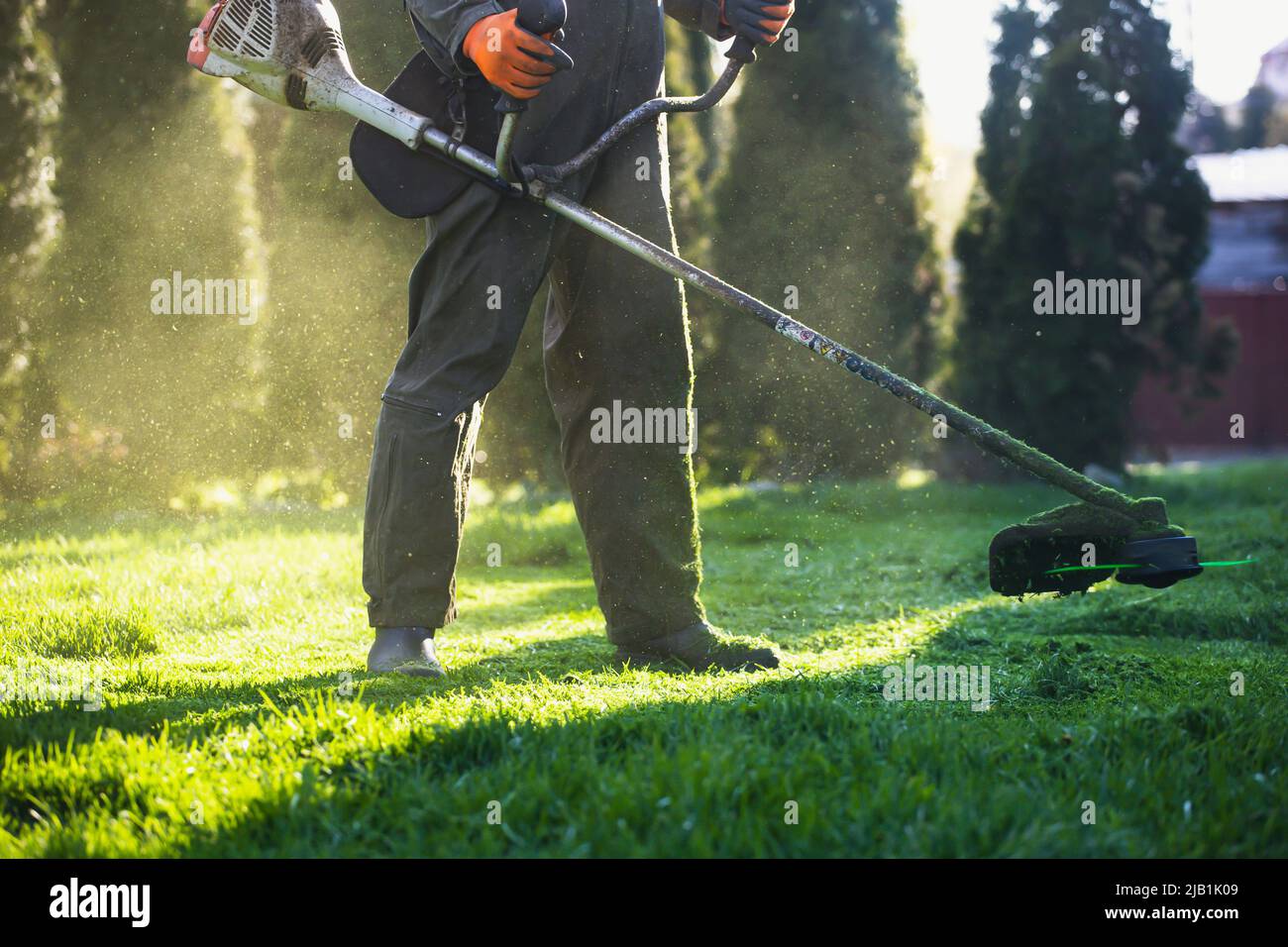 Mowing the grass with a lawn mower. Garden work concept background ...