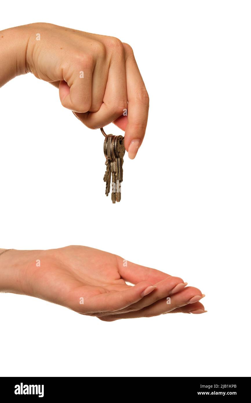 A hand holding keys on a white background Stock Photo - Alamy