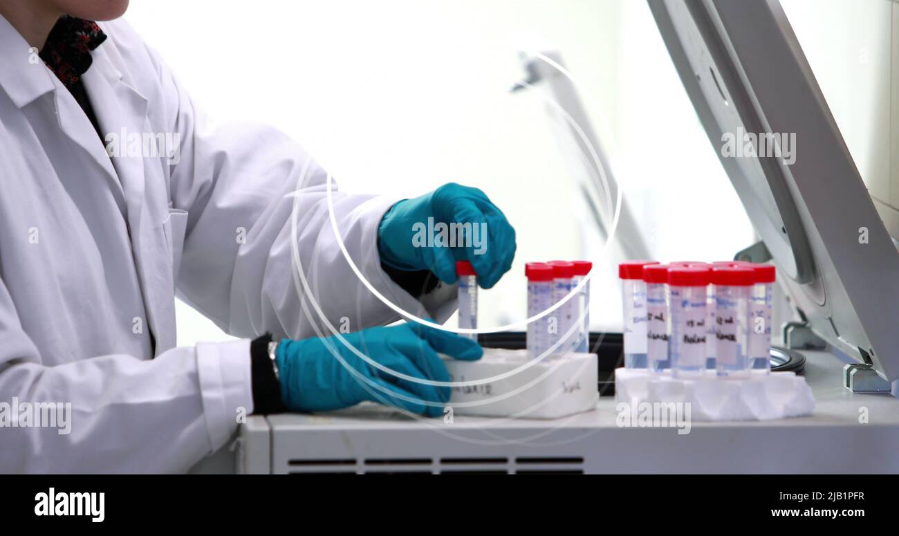 Image of circles over female scientist in laboratory Stock Photo - Alamy