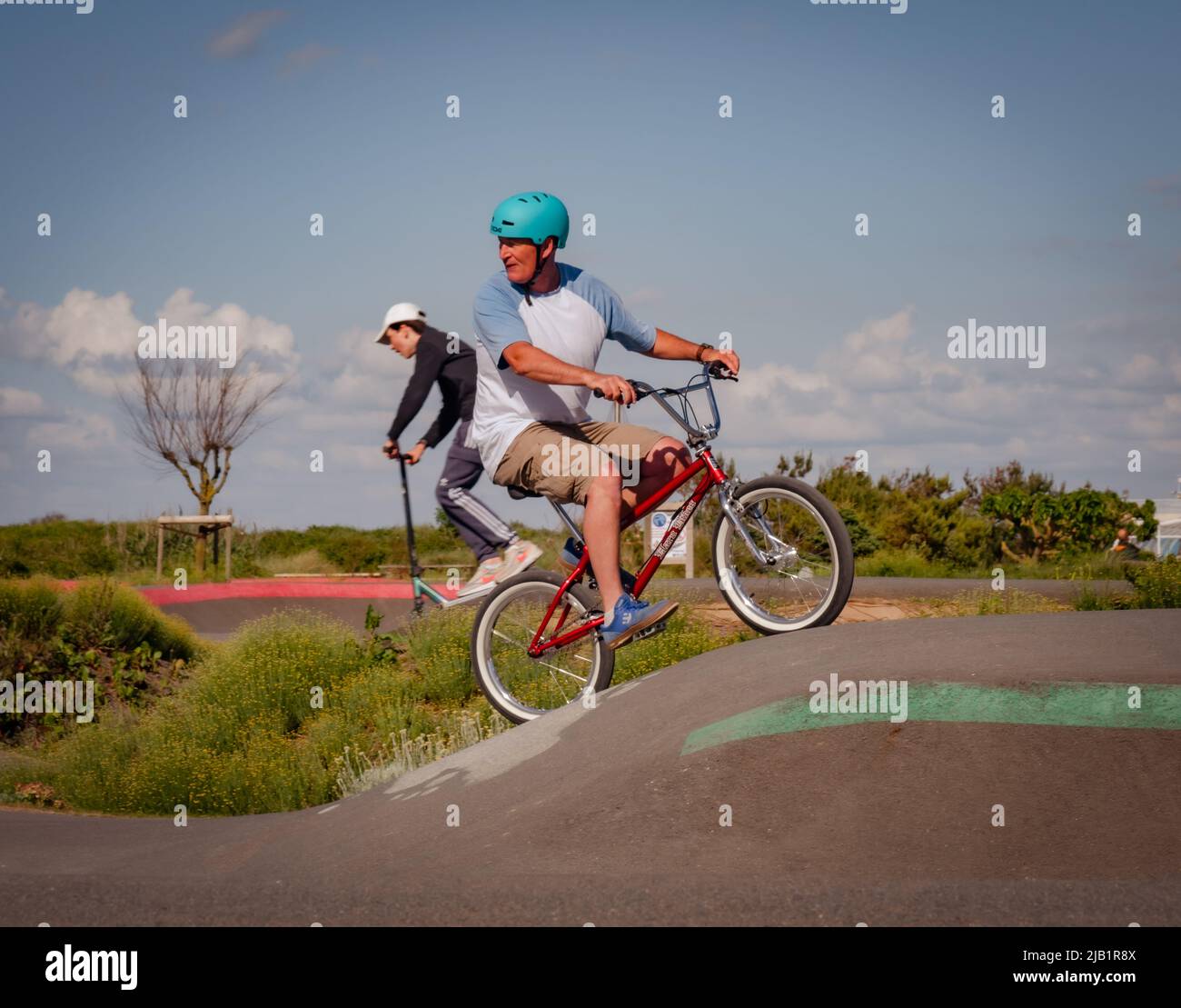 Merville, France, May 2022. Man with a helmet riding a BMX bike in the ...