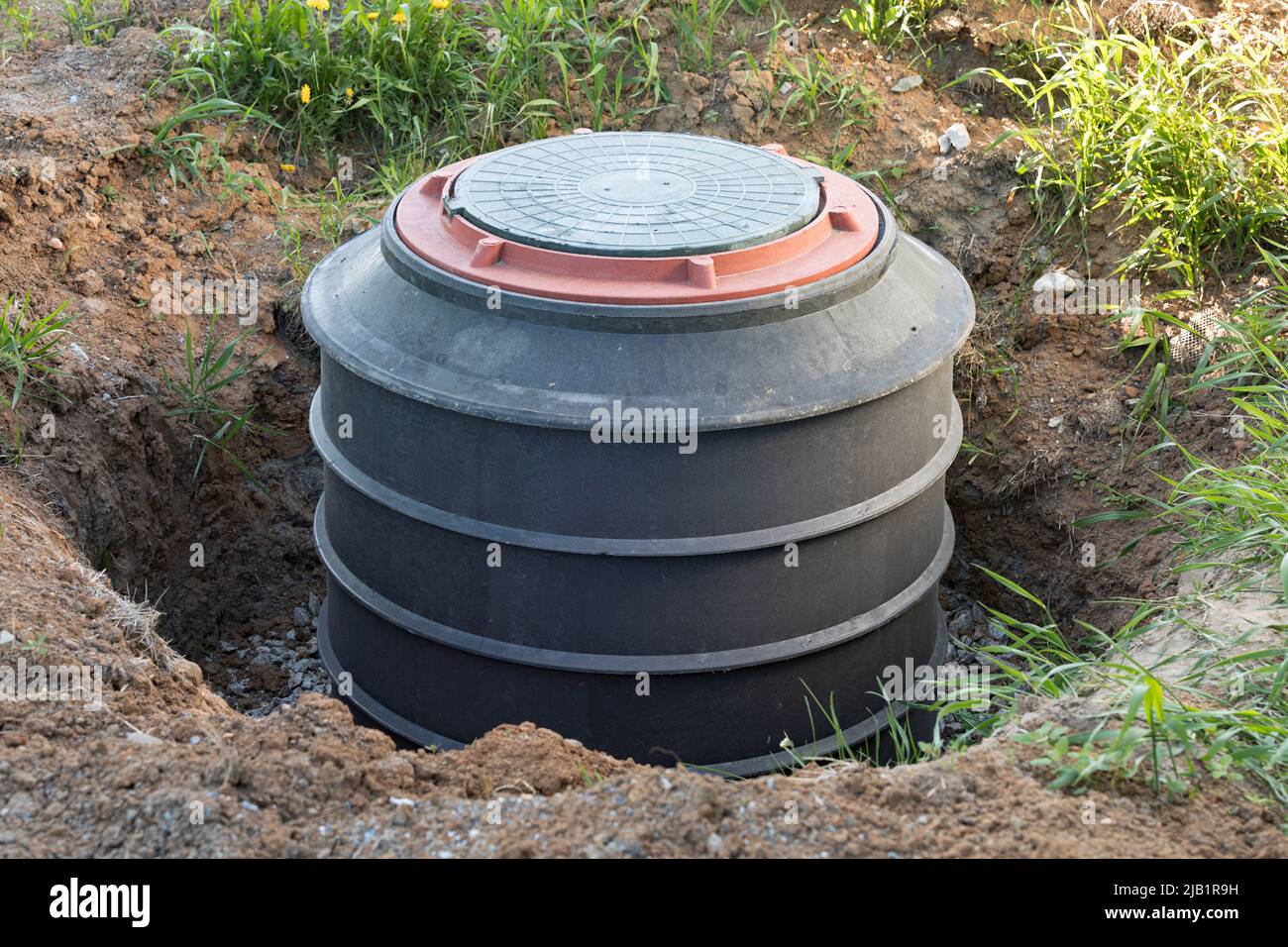 Installation of underground tank for sewage system Stock Photo - Alamy