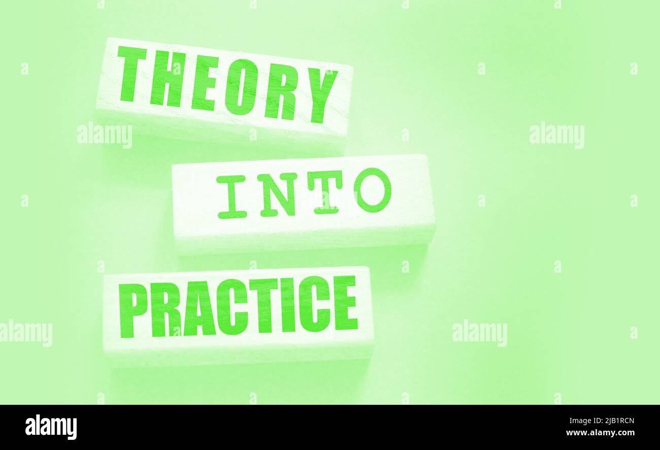 Theory into practice words written on wooden blocks. Education or ...