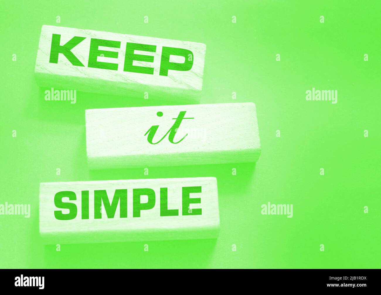 Keep it simple words on wooden blocks on dark gray background. Business ...