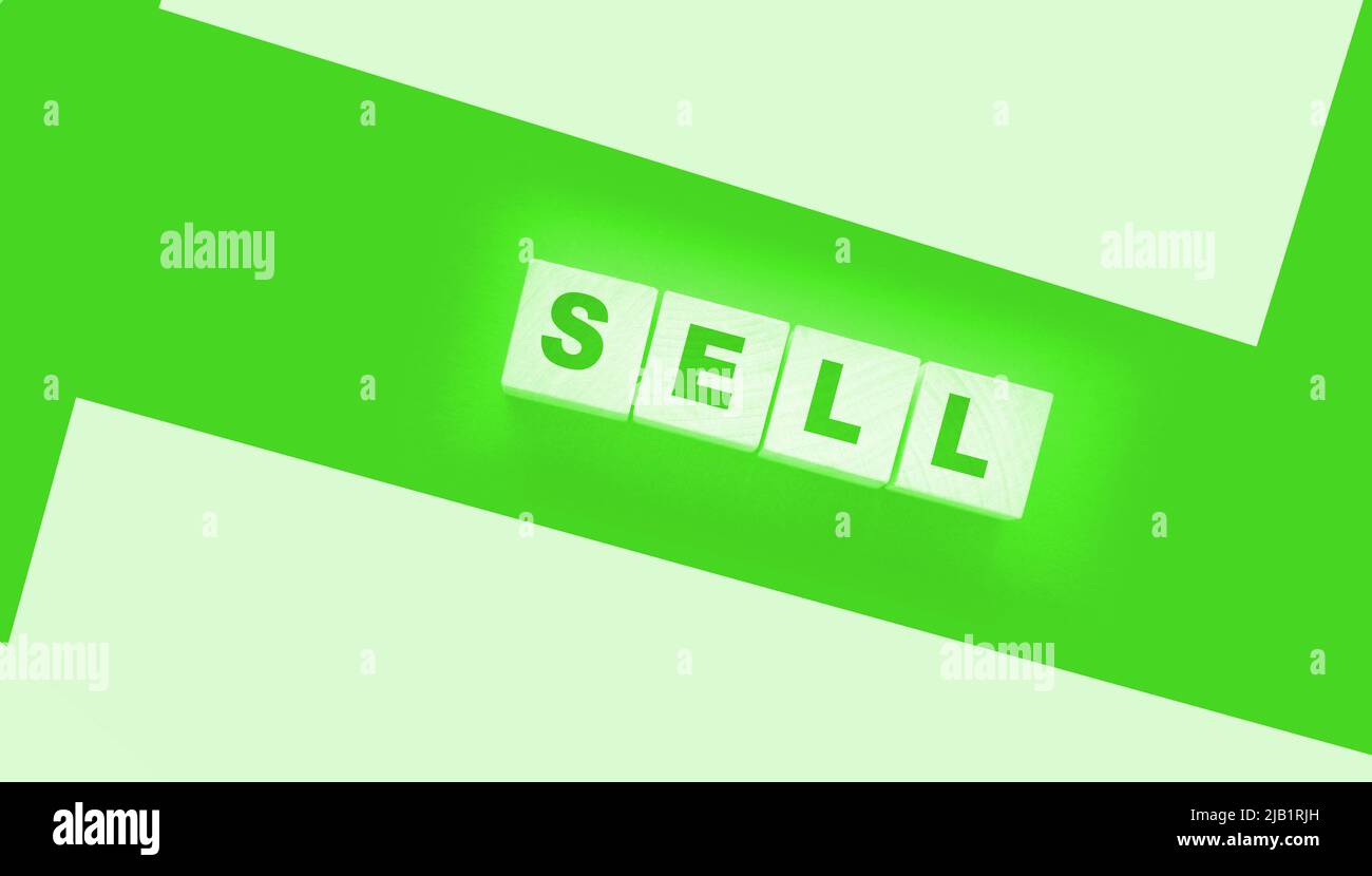 Wooden cubes with word sell on the dark background. Shopping concept ...